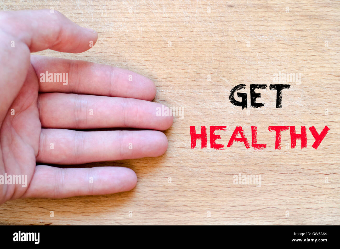 Human hand over wooden background and get healthy text concept Stock ...