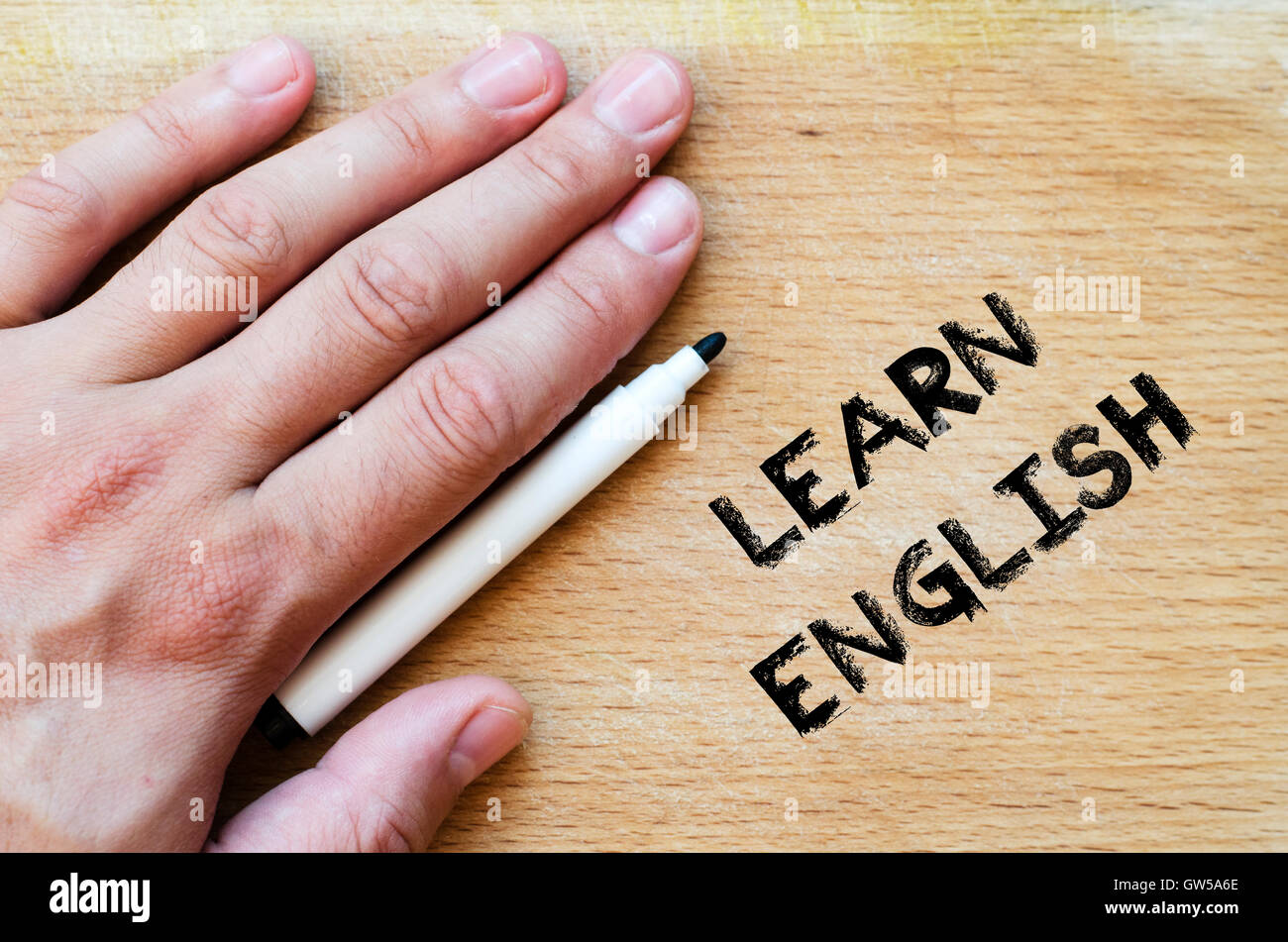 Human hand over wooden background and learn english text concept Stock ...