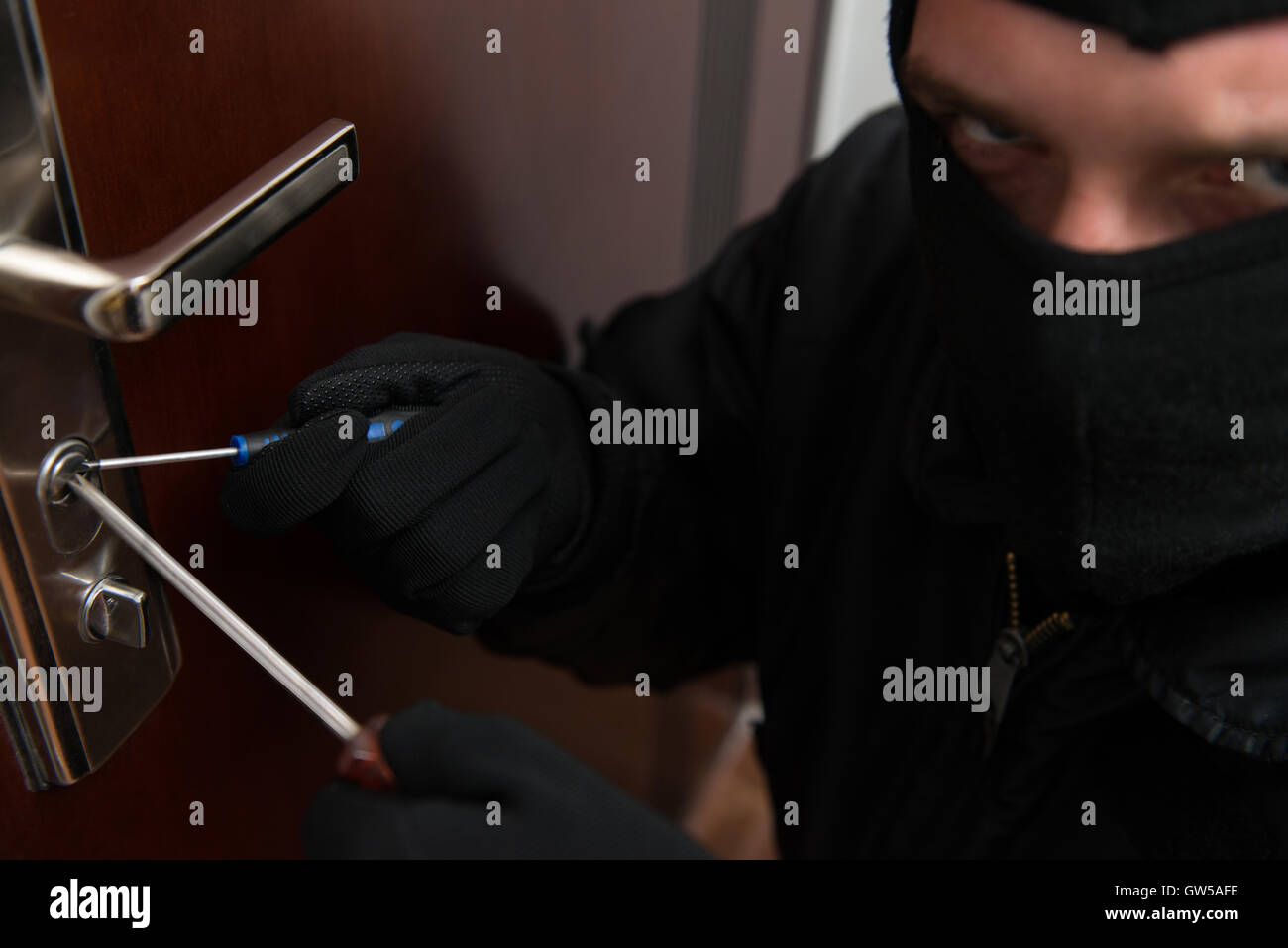 Thief Burglar Force Lock Metal Door With A Tool During House Breaking ...