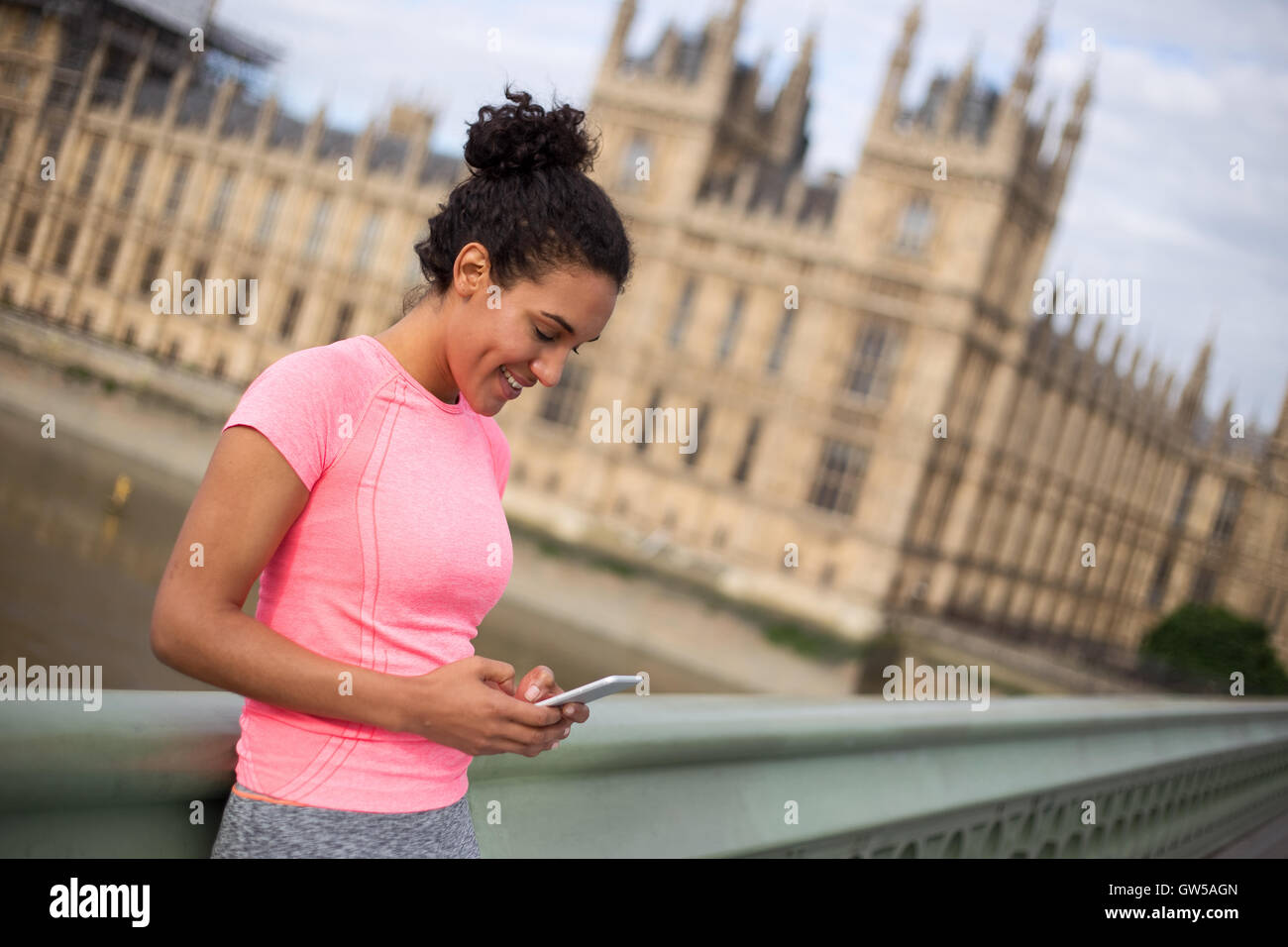 young woman checking her text messages while out running Stock Photo ...