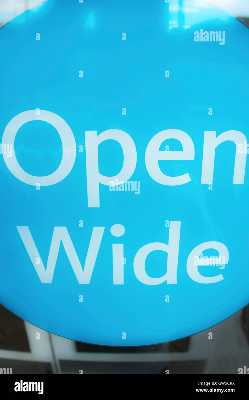 An 'Open Wide' sign on a dentists door Stock Photo - Alamy