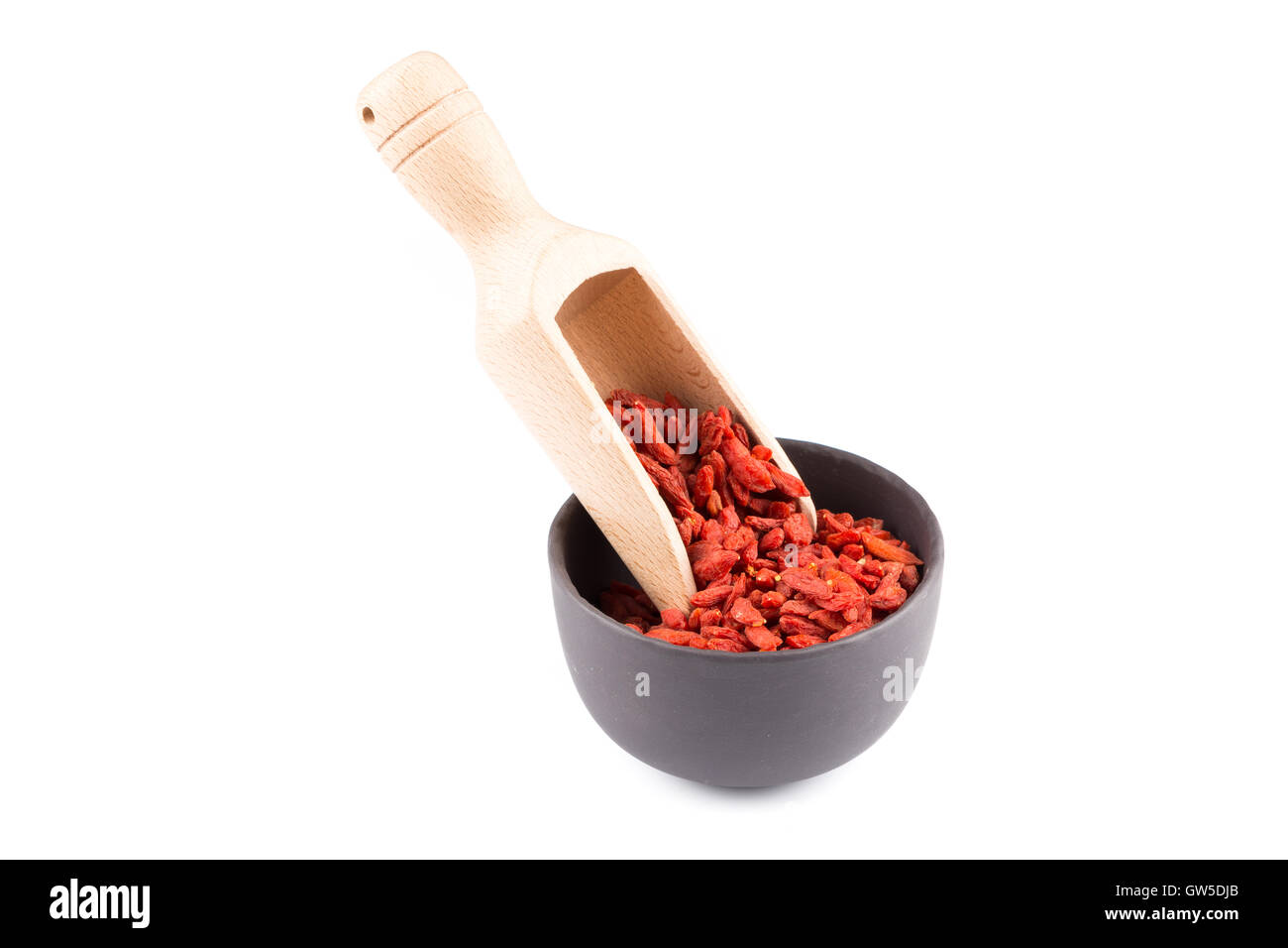 Chinese goji berries in bowl with scoop close up on white background ...