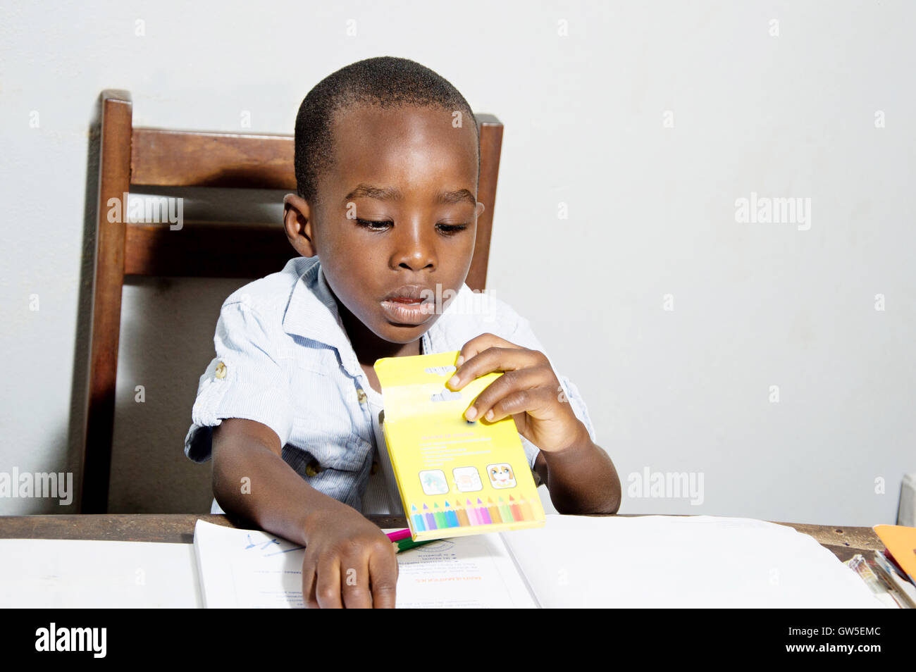 child looks in the box colored pencils counting mentally Stock Photo ...
