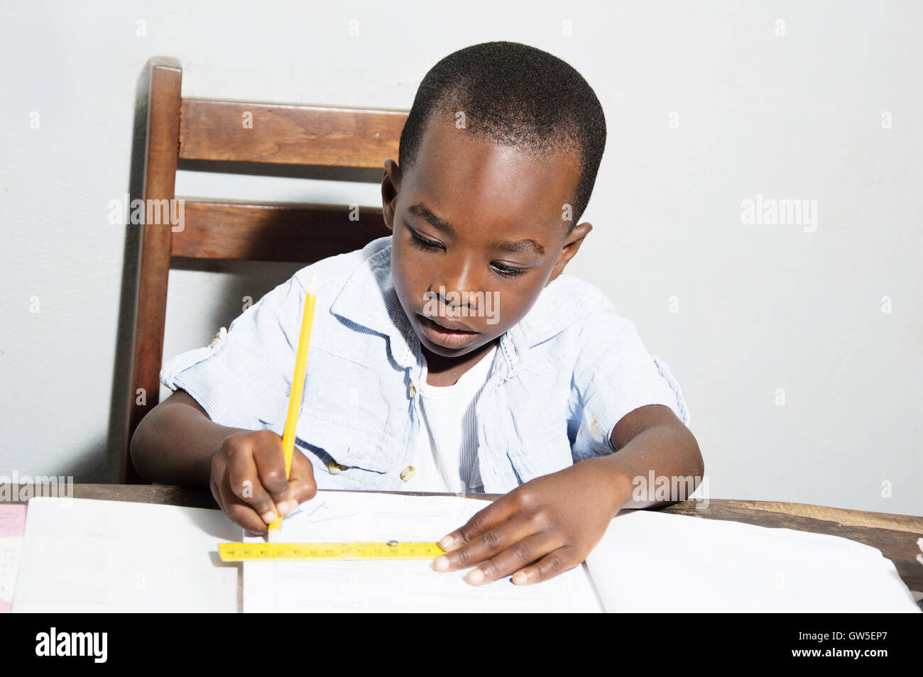 Child draws a line in pencil with a wooden ruler Stock Photo - Alamy