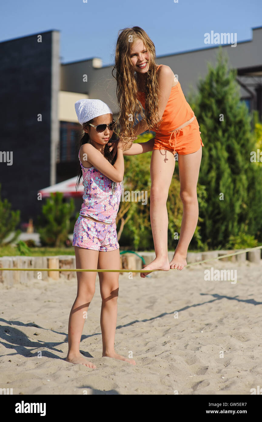 Two girls having fun on sling Stock Photo - Alamy
