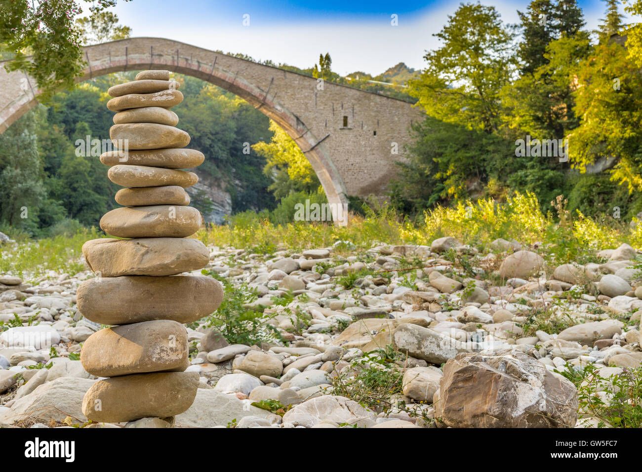 pile of stones in front of 500 years old hunchback Renaissance bridge ...