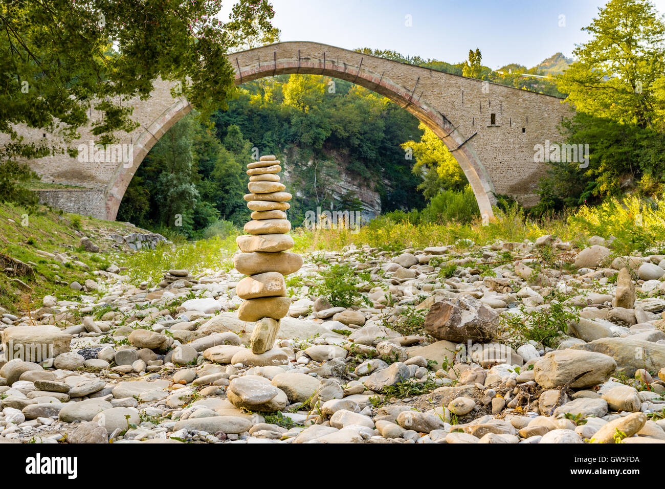 pile of stones in front of 500 years old hunchback Renaissance bridge ...