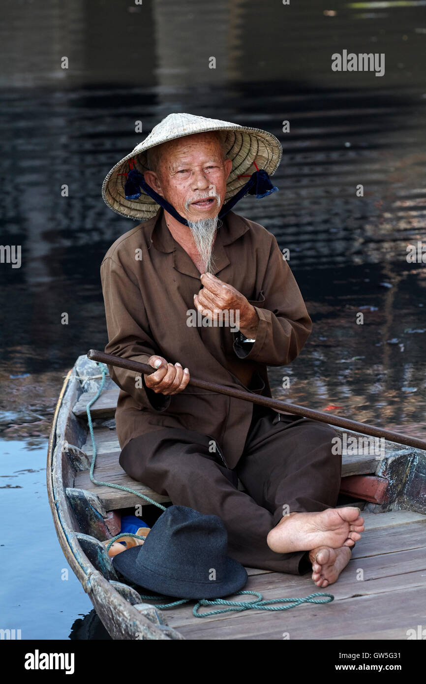 Elderly man with goatee and conical hat in boat, Hoi An (UNESCO World ...