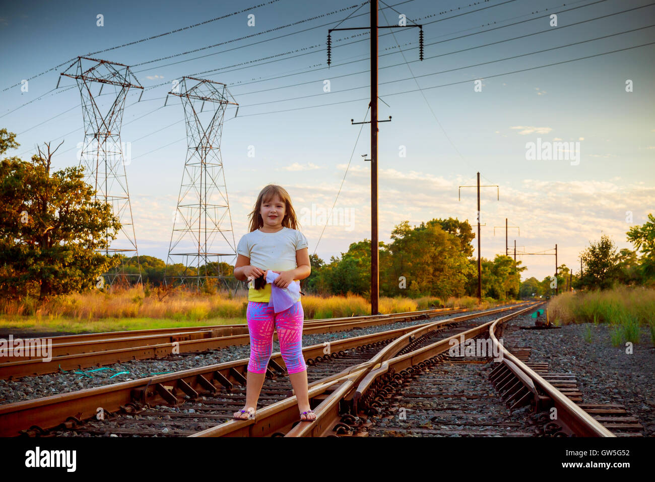 little girl with the railroad. near tracks Stock Photo - Alamy