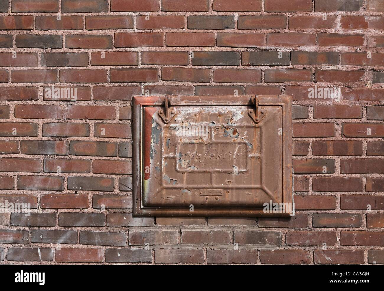 A weird metal plate on a brick wall Stock Photo - Alamy