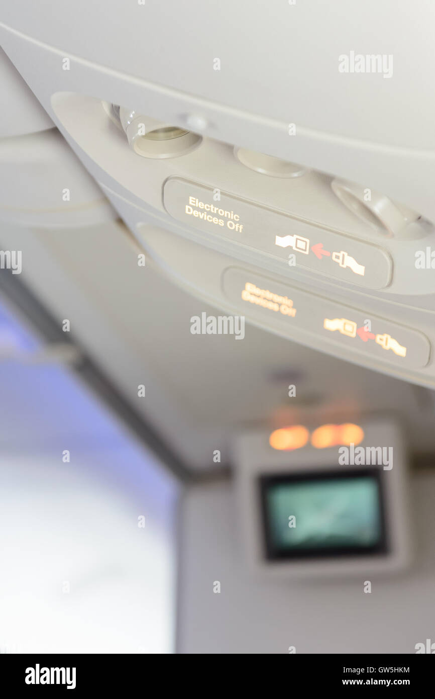 Electronic devices off and fasten seat belt sign inside airplane Stock ...