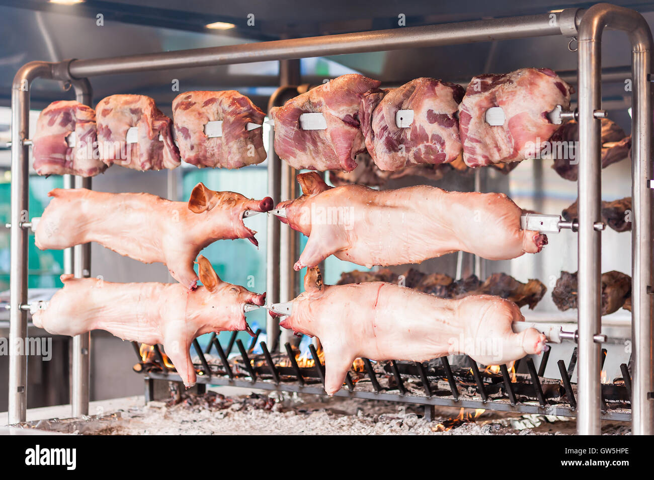 Carcasses of pork and other meat prepared on skewer. Cooking on grill ...