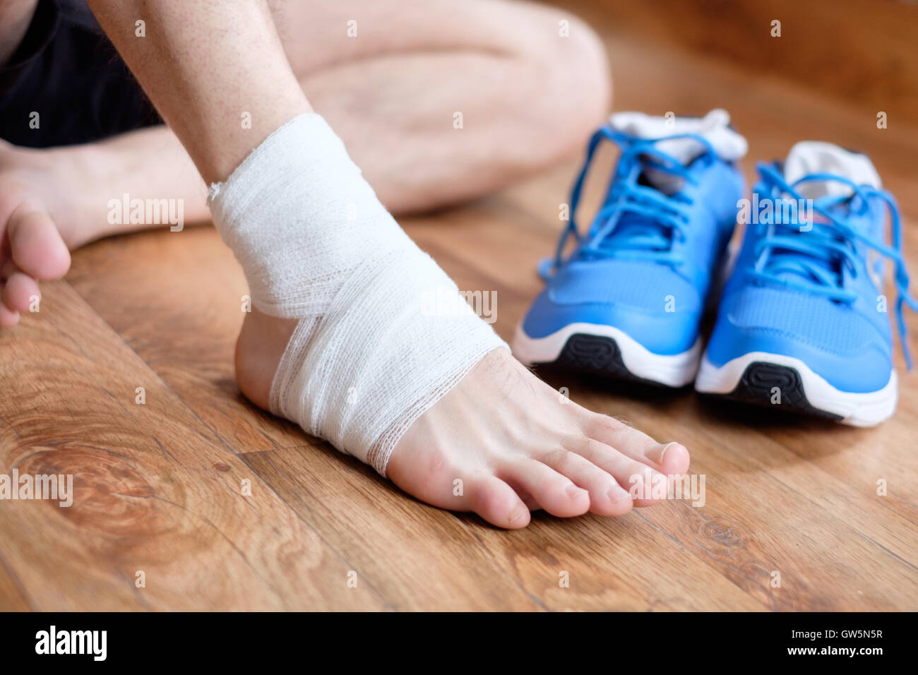 sportsman massaging his injured ankle after a sport accident Stock ...