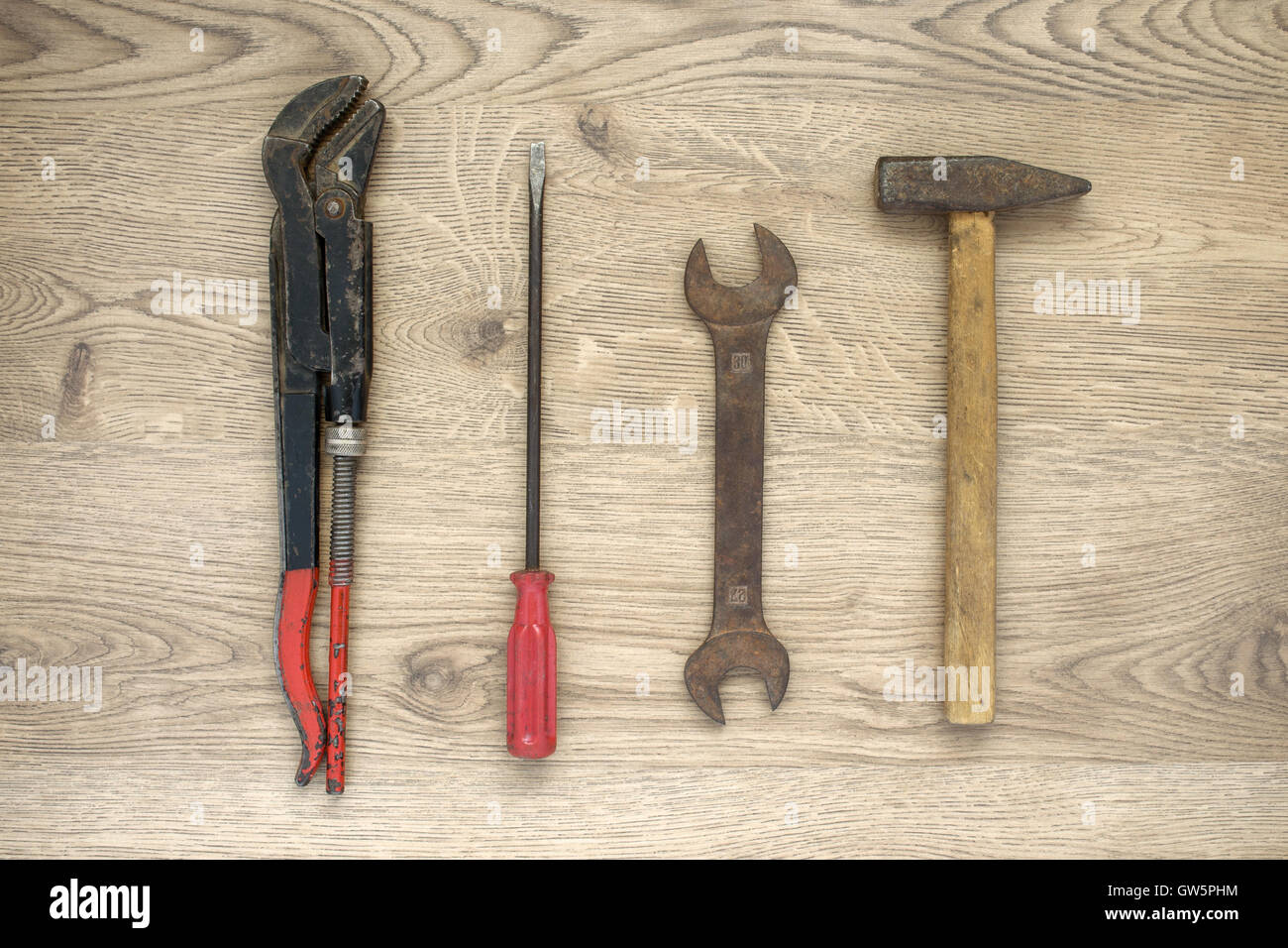 Rusty old hand tools on wooden background Stock Photo - Alamy