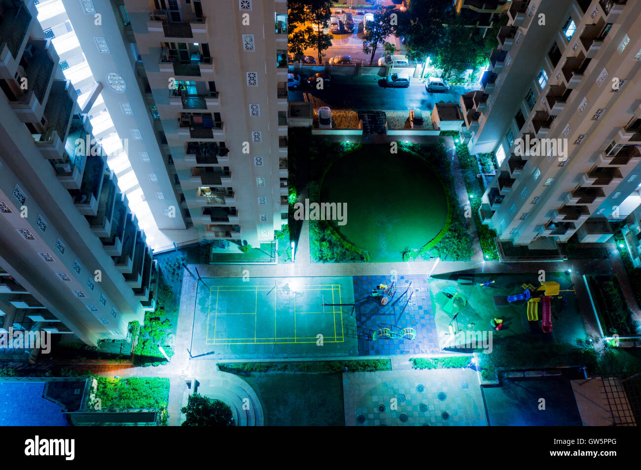 Tennis, basketball courts in skyscraper courtyard Stock Photo - Alamy