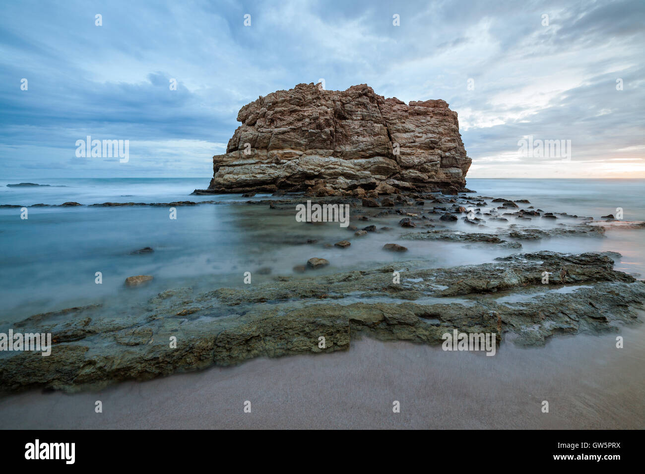 Big rock beach sunset long exposure Stock Photo - Alamy