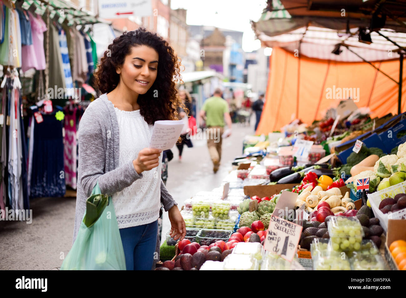 young woman at the market reading her shopping list Stock Photo - Alamy