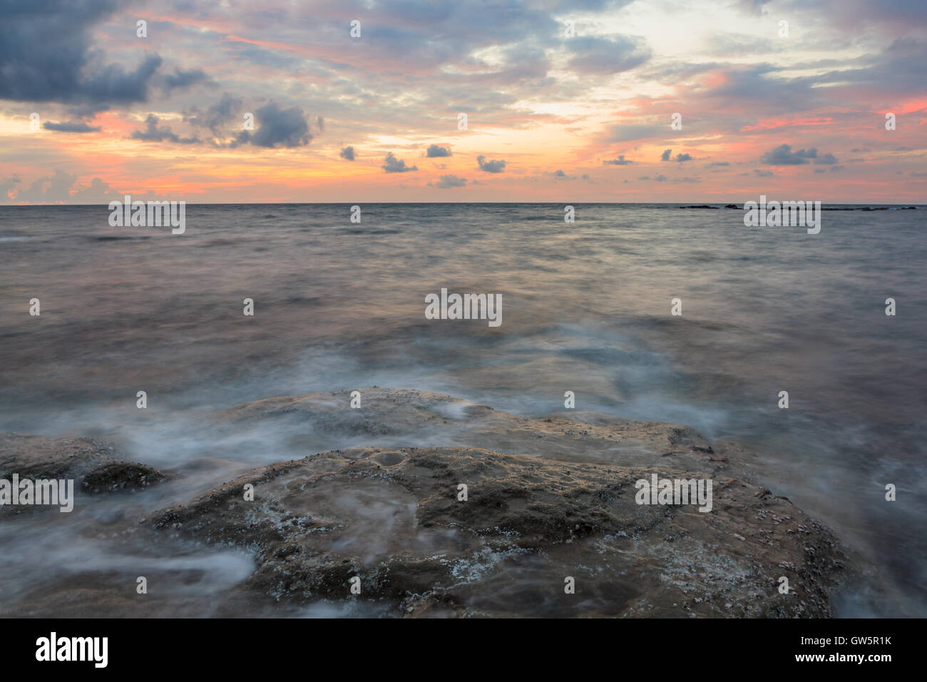 Long exposure sea and rocks at twilight Stock Photo - Alamy