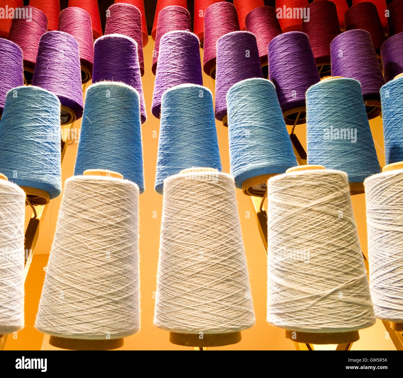 Spools of colorful thread used for weaving, stitching and designing in ...