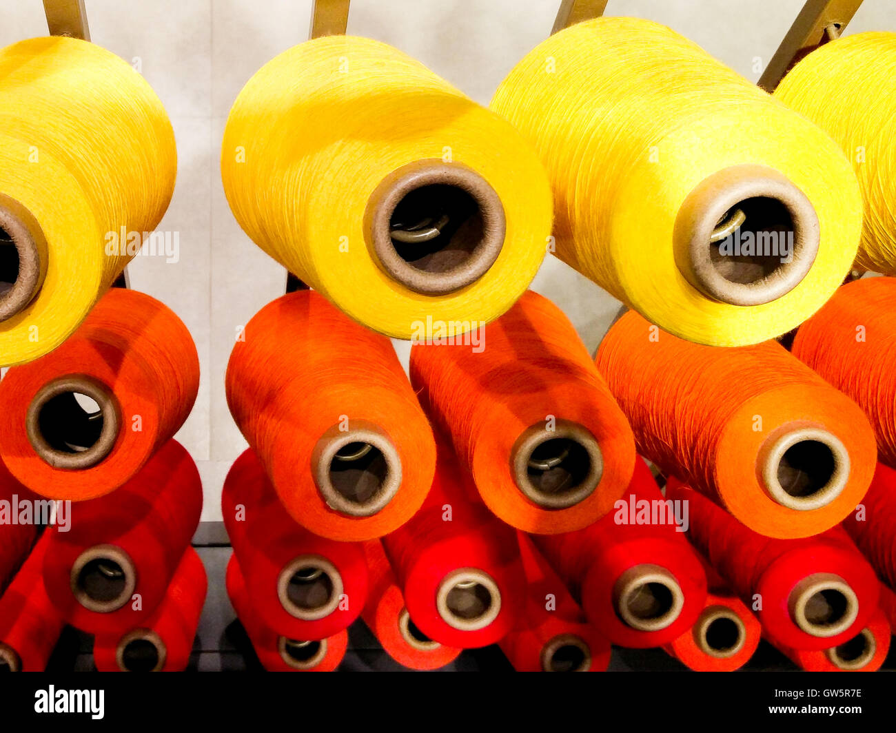 Spools of colorful thread used for weaving, stitching and designing in ...