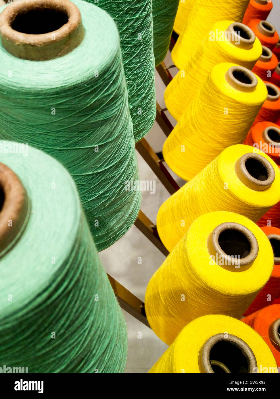Spools of colorful thread used for weaving, stitching and designing in ...