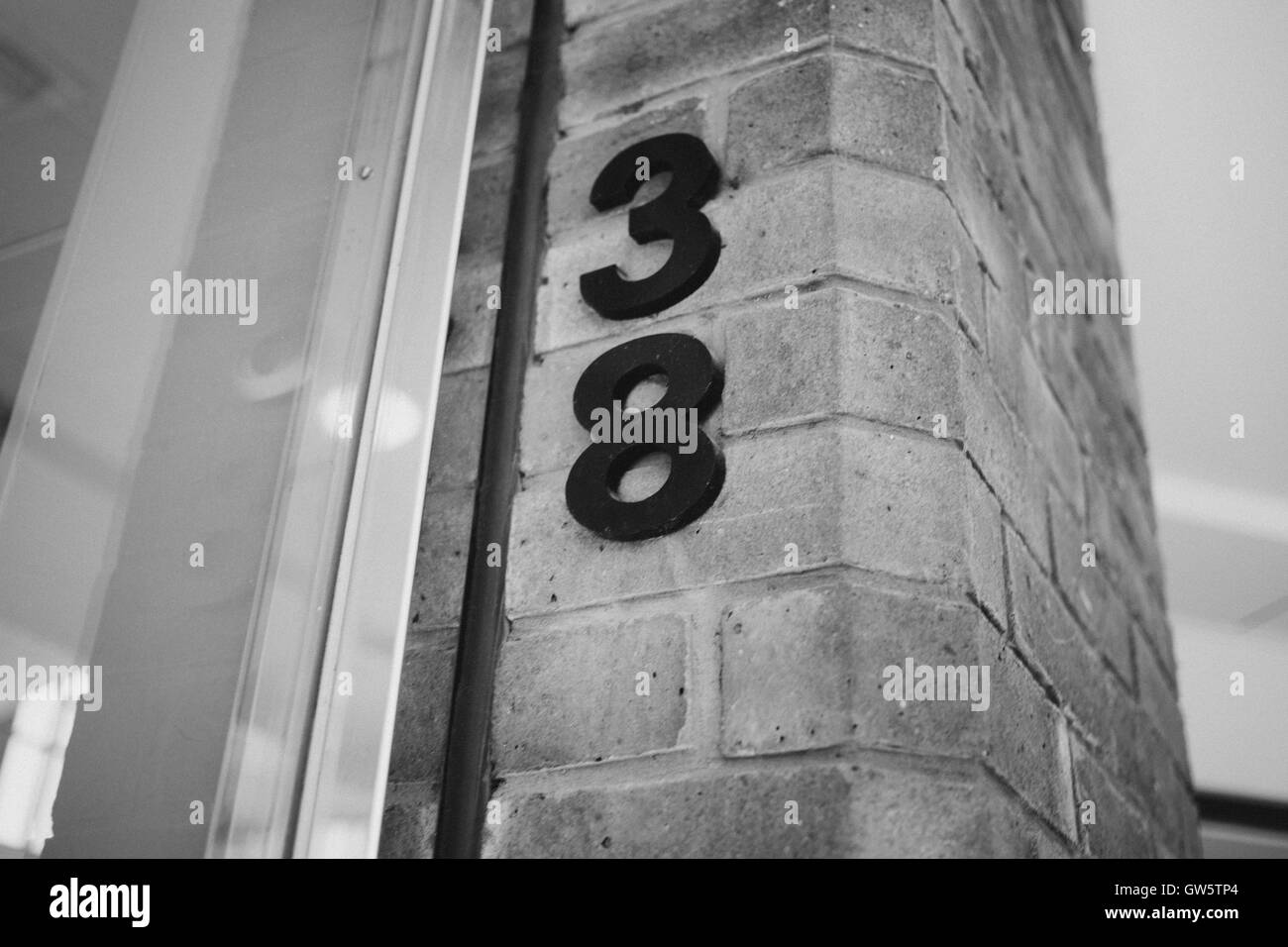 '38' in plastic lettering on brick wall Stock Photo - Alamy