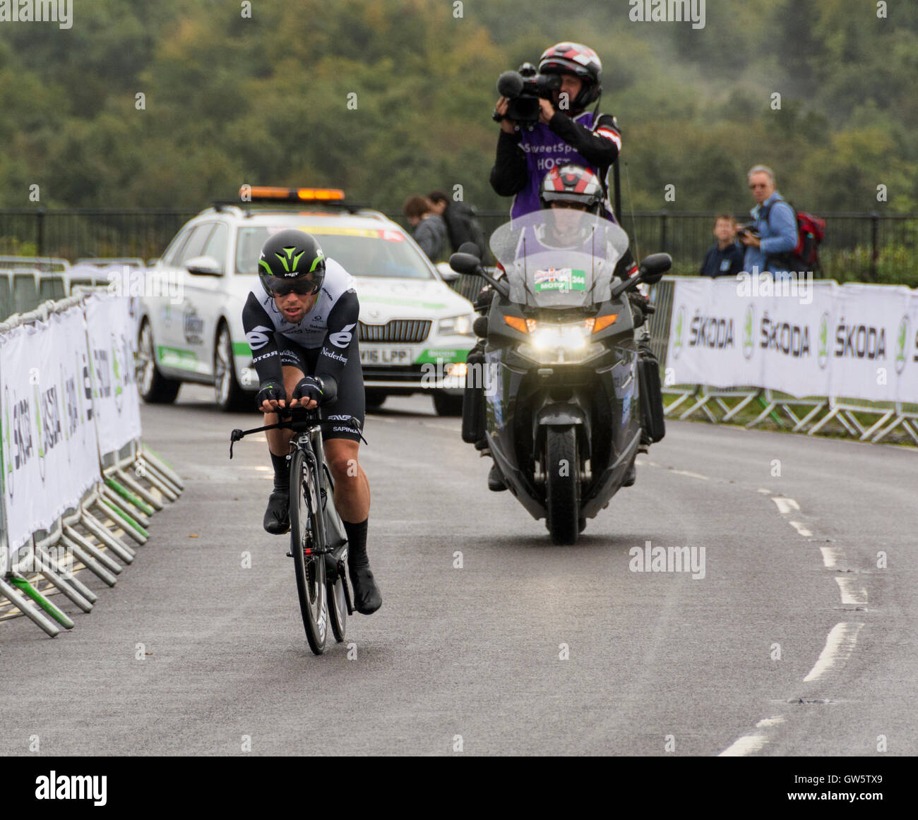 Mark Cavendish with camera crew and support vehicle doing the time ...