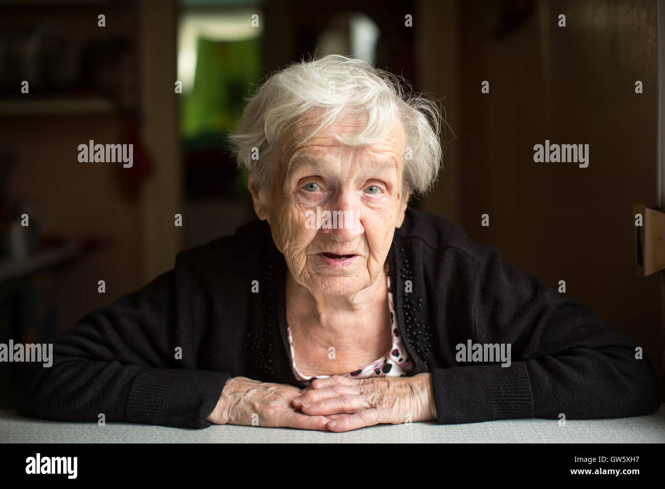 Elderly lady portrait inside the house Stock Photo - Alamy