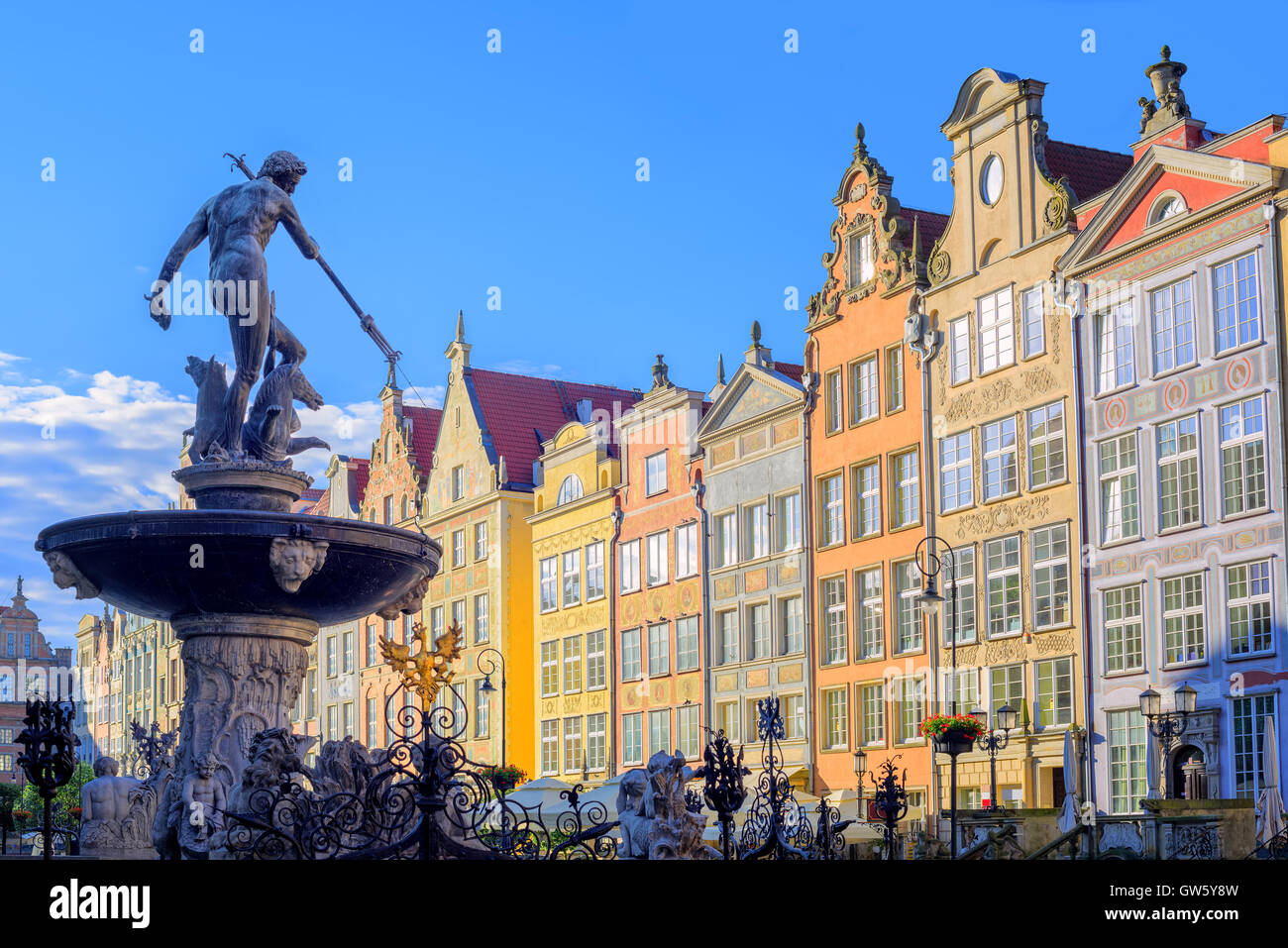 Neptune fountain statue in Gdansk with colorful gothic houses in the ...