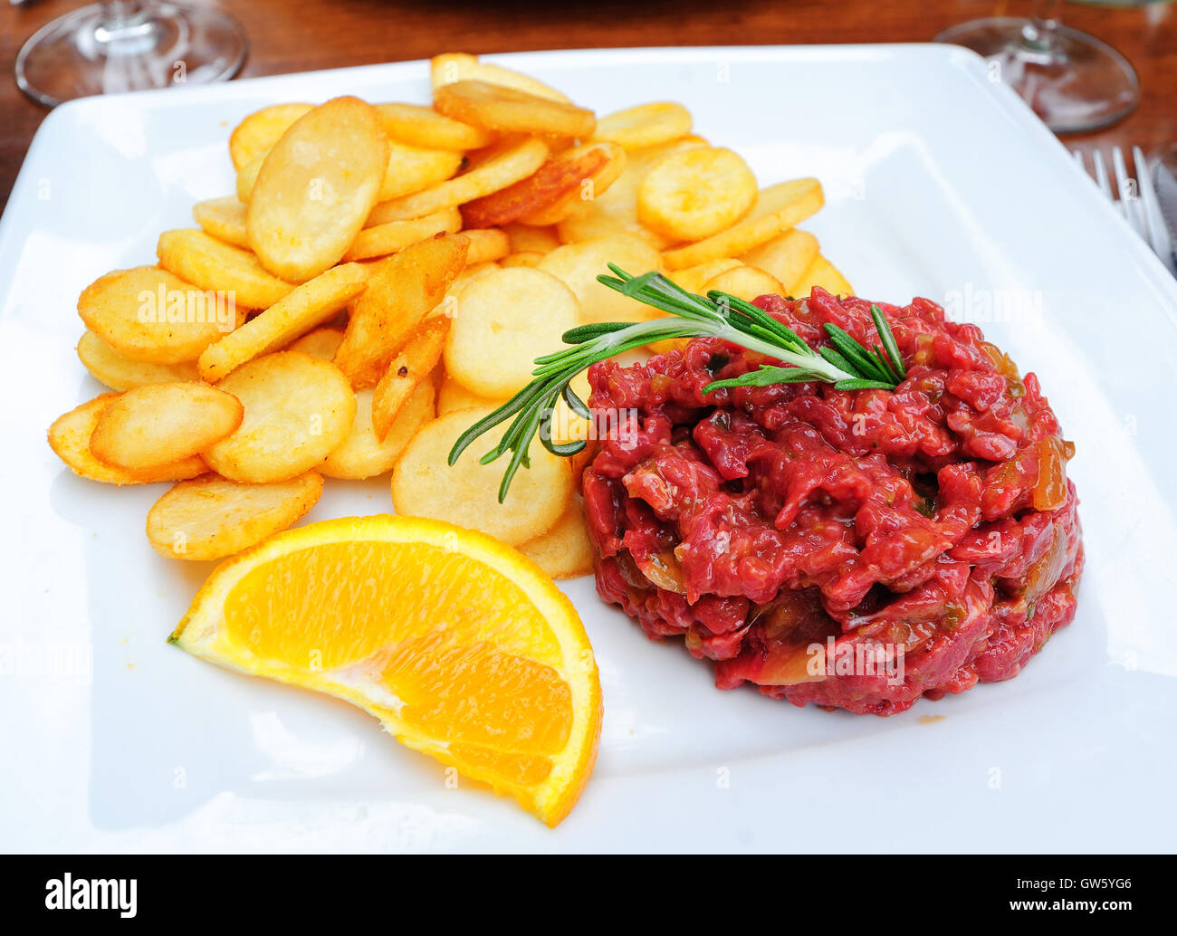 Steak tartare raw minced beef meat served with french fries potato ...
