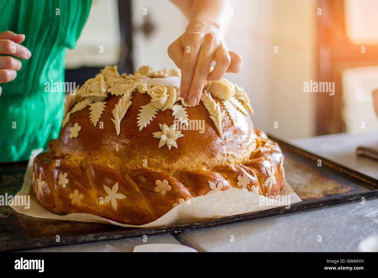 Lady's hand touches decorated pastry Stock Photo - Alamy