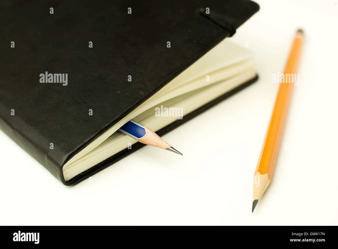 Diary and pencils on white Stock Photo - Alamy