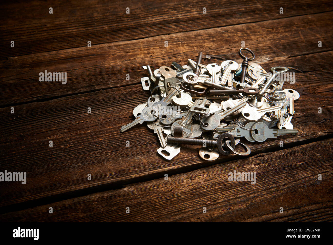 Pile of keys on a grunge wooden background Stock Photo - Alamy