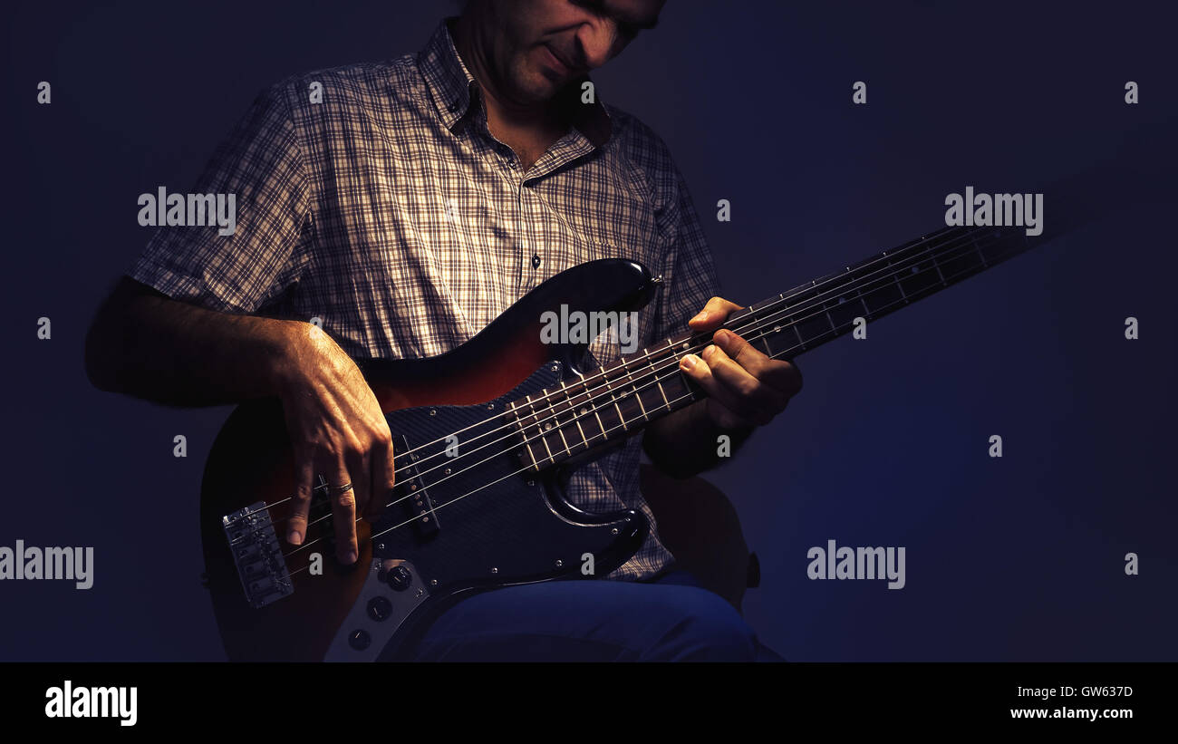 Bass player and his guitar, expressions while playing Stock Photo - Alamy