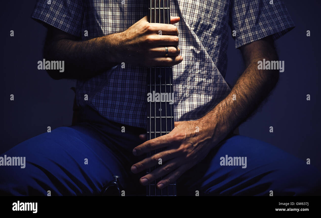 Hands of a bass player, closeup view on an instrument and body Stock ...