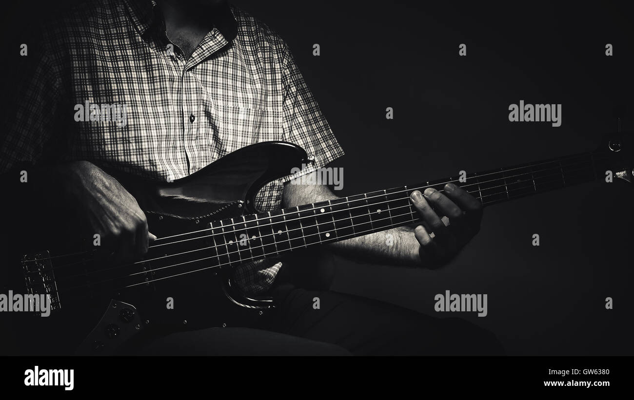 Bass player and his guitar, expressions while playing Stock Photo - Alamy