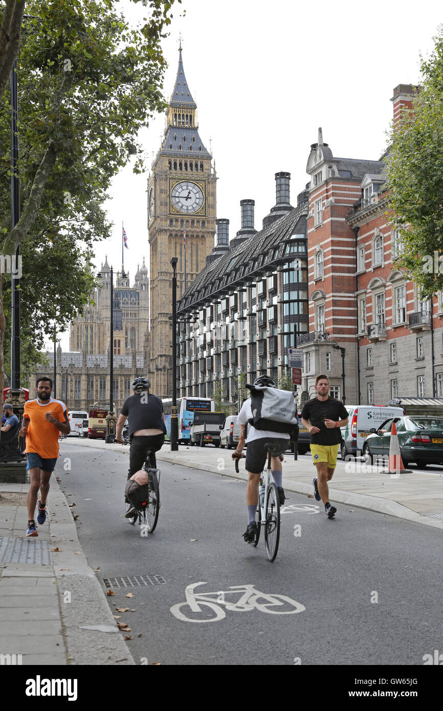 Cyclists and runners use the new east-west cycle superhighway along ...