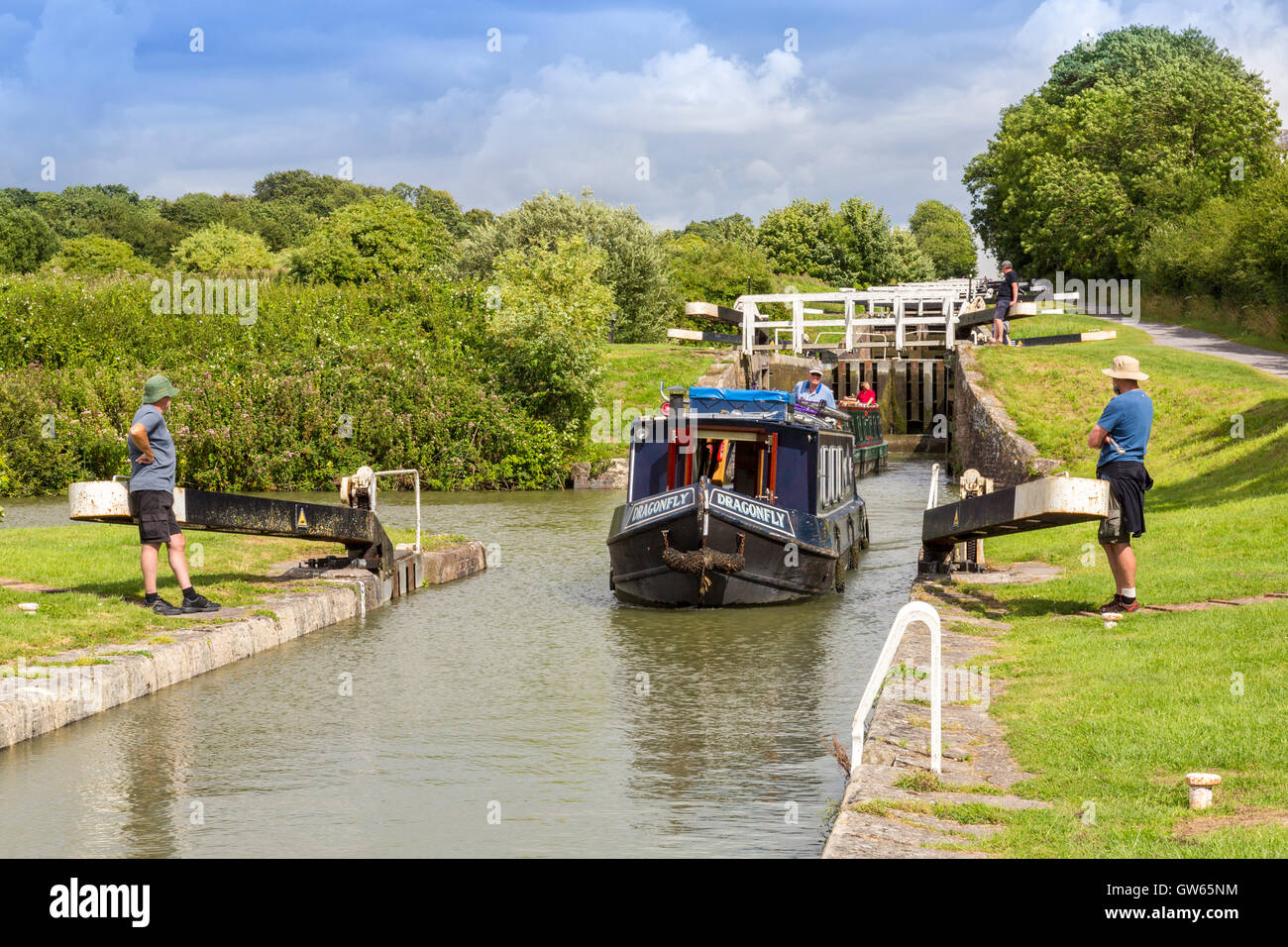 Colourful barges entering one of the 16 Caen Hill locks on the Kennet ...