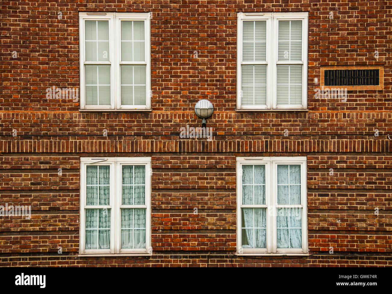 London, four white windows on red bricks Stock Photo - Alamy