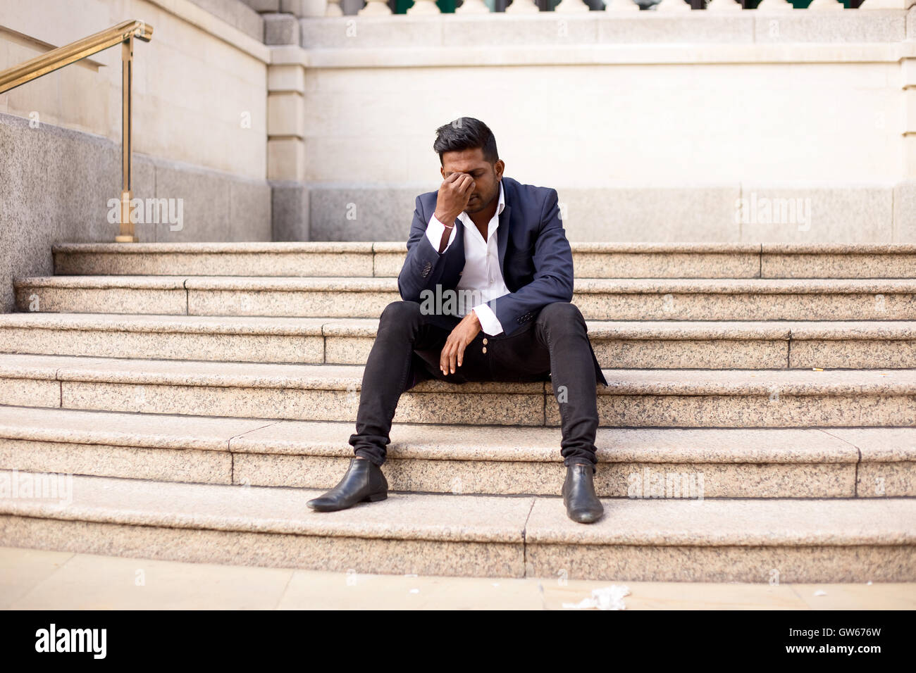 Indian man sitting on steps hi-res stock photography and images - Alamy