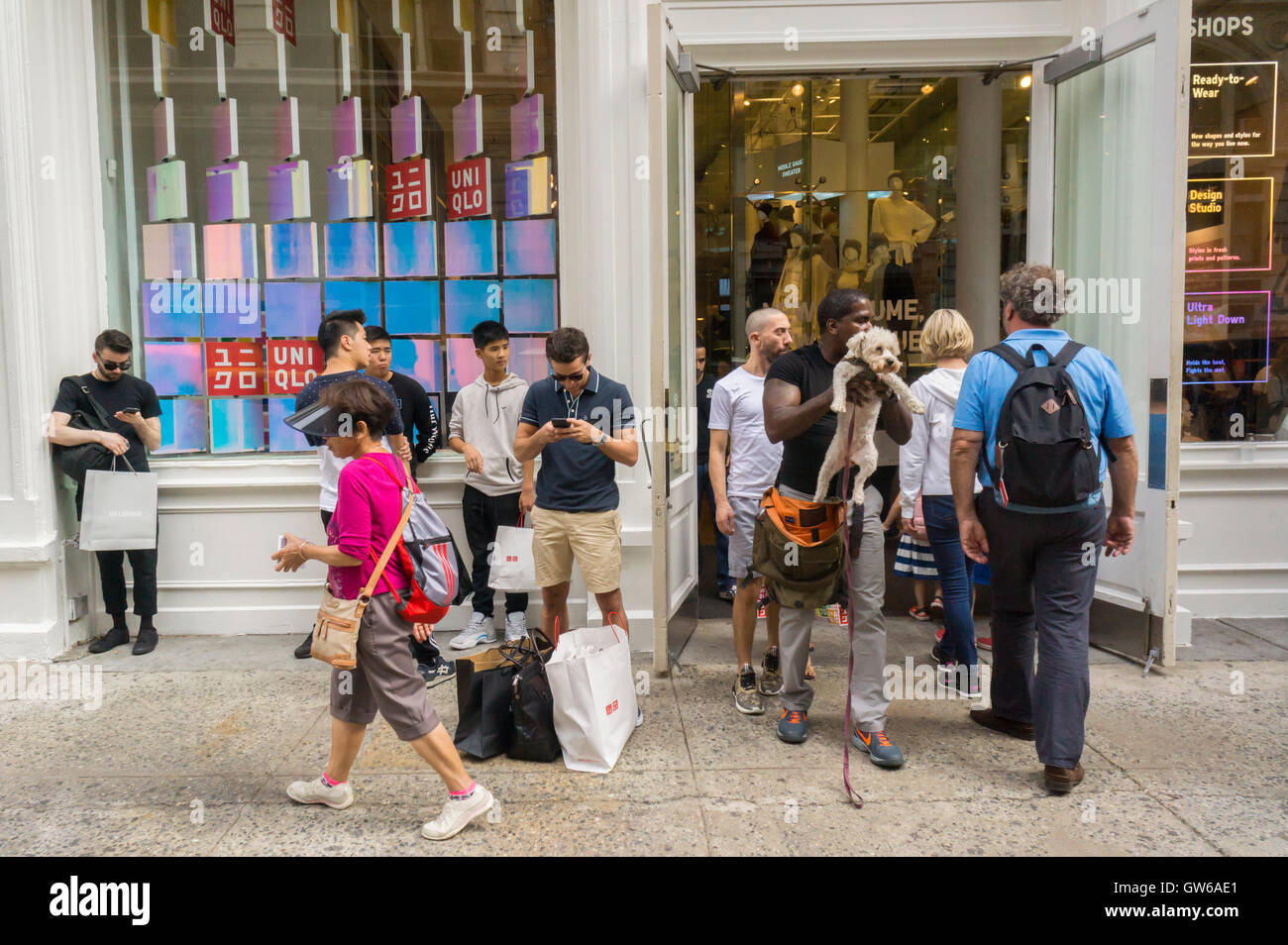 Shopping outside the newly renovated Uniqlo store in Soho in New York ...
