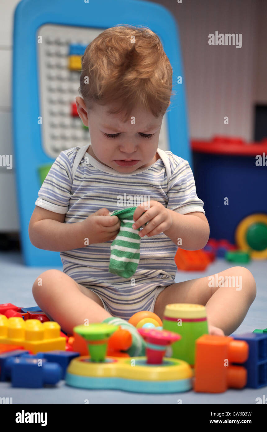 A baby boy crying in children's room Stock Photo - Alamy