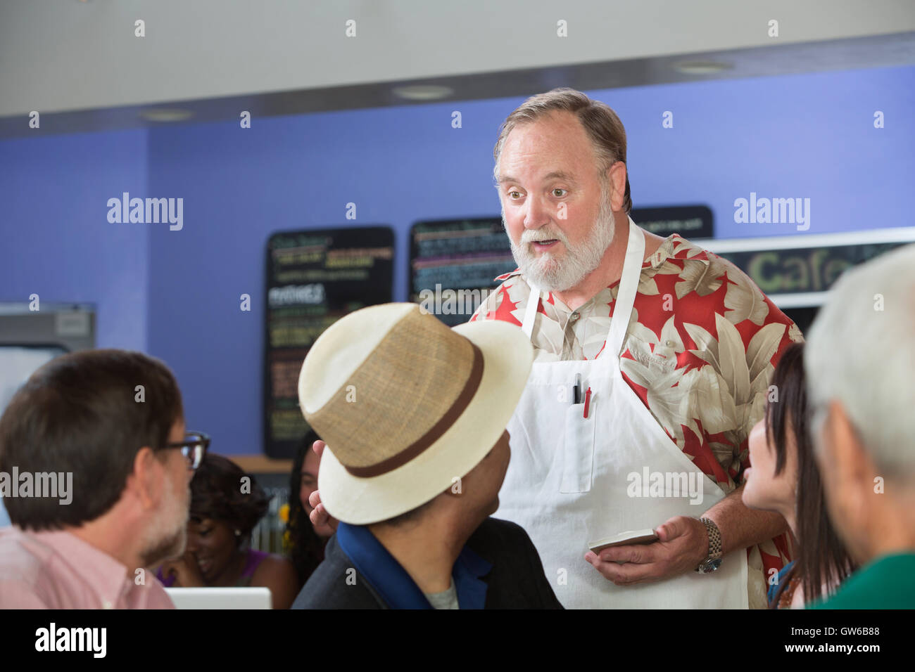Cafe Employee Helping Customers Stock Photo - Alamy