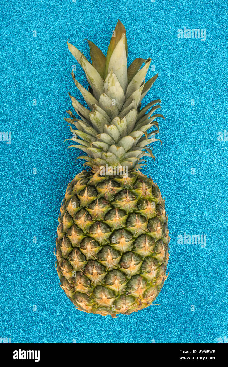 Single pineapple on a shiny blue background Stock Photo - Alamy