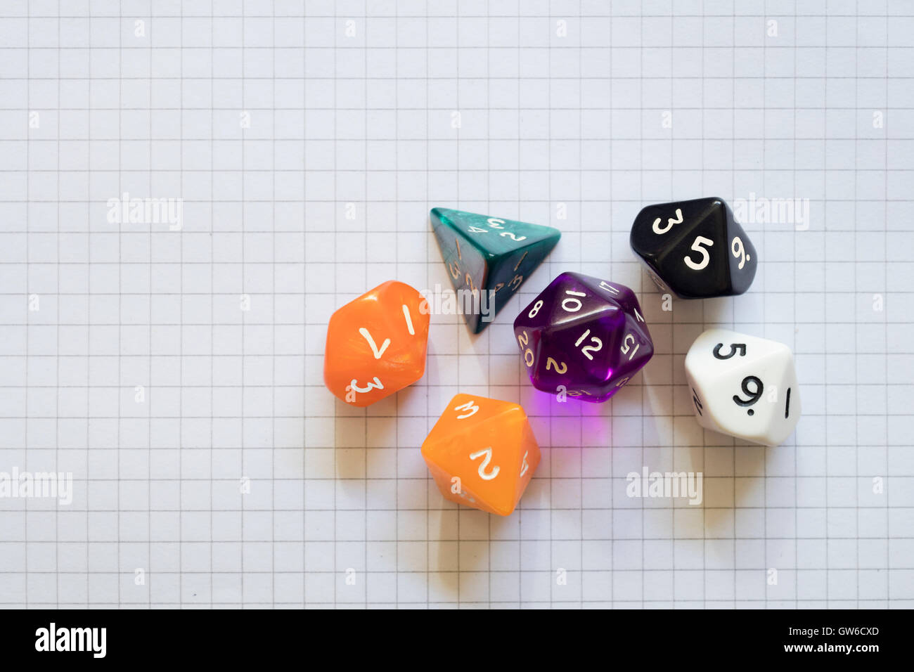 Group of role dices on a paper background Stock Photo - Alamy