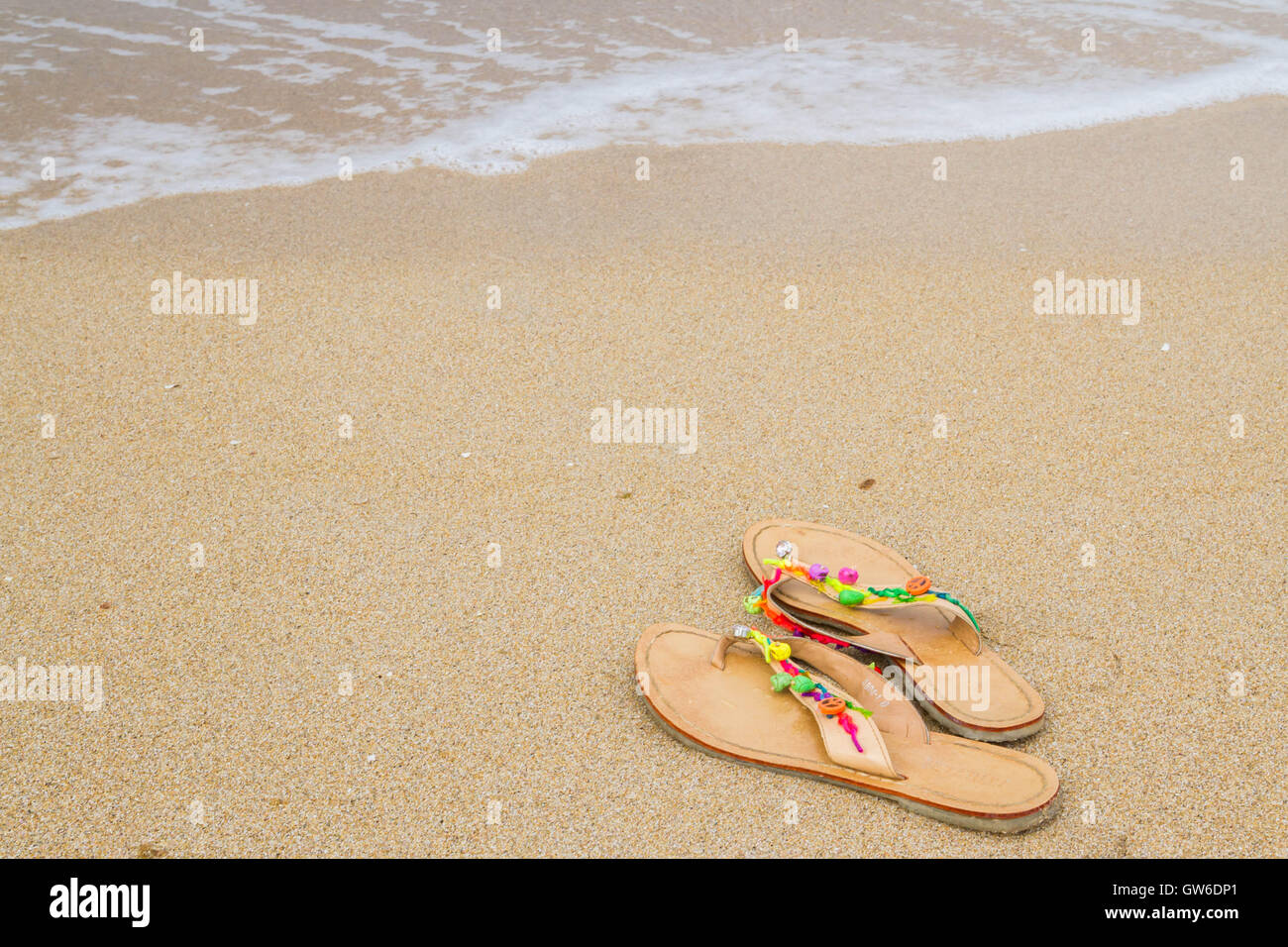 Summer flip flops on the beach Stock Photo - Alamy