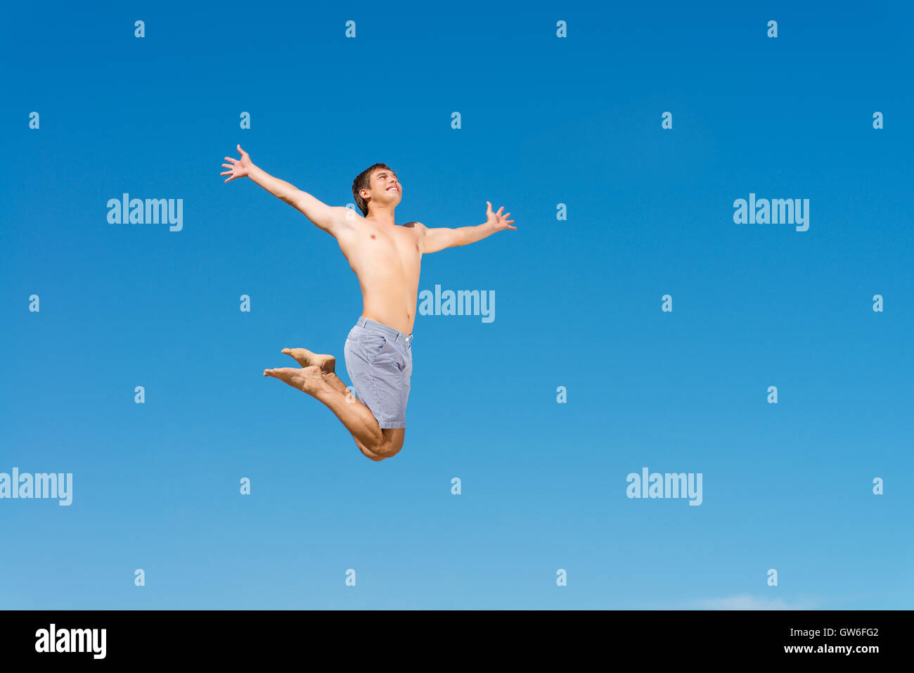 young man jumping Stock Photo - Alamy