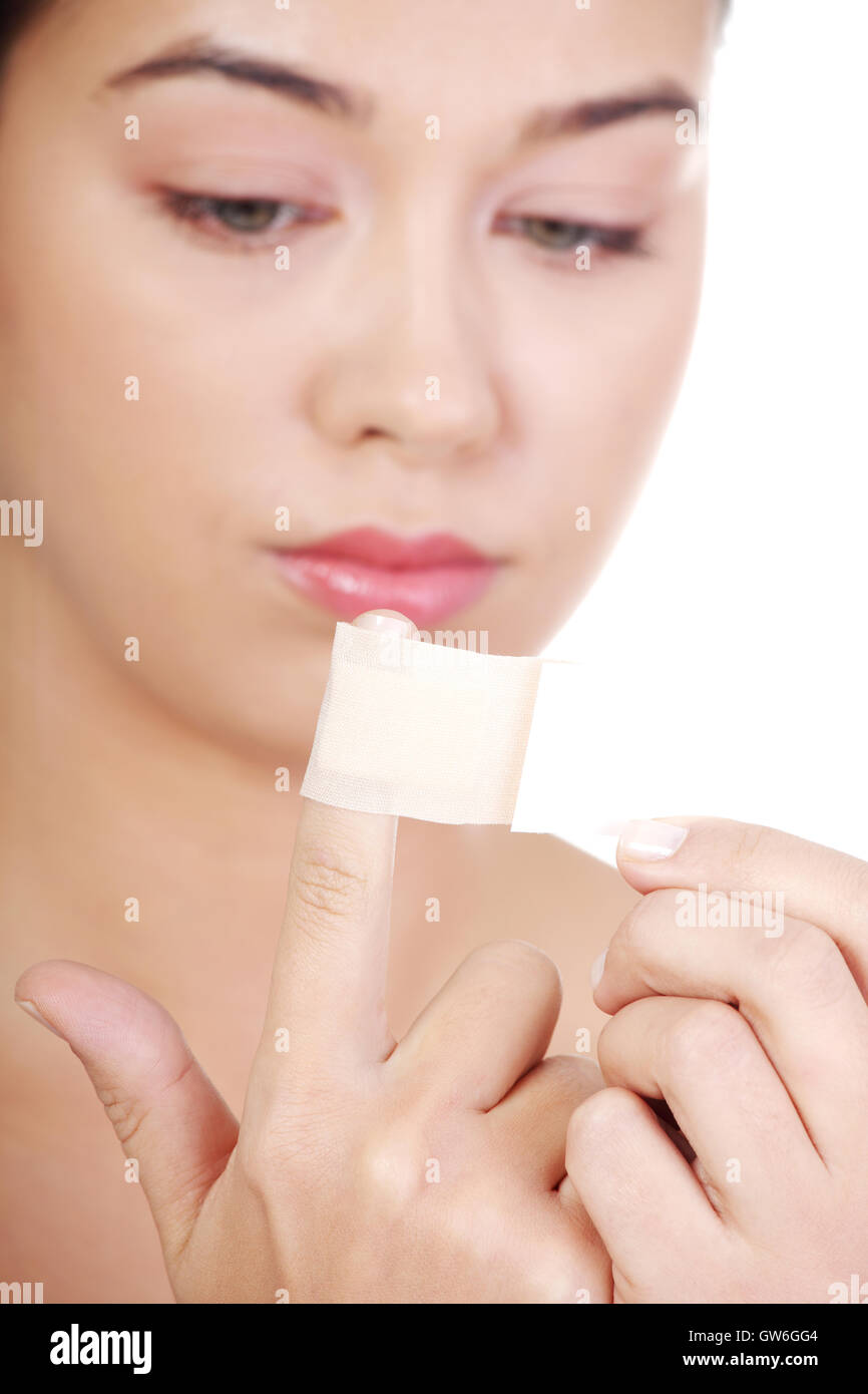Preaty young woman using adhesive plaster Stock Photo - Alamy
