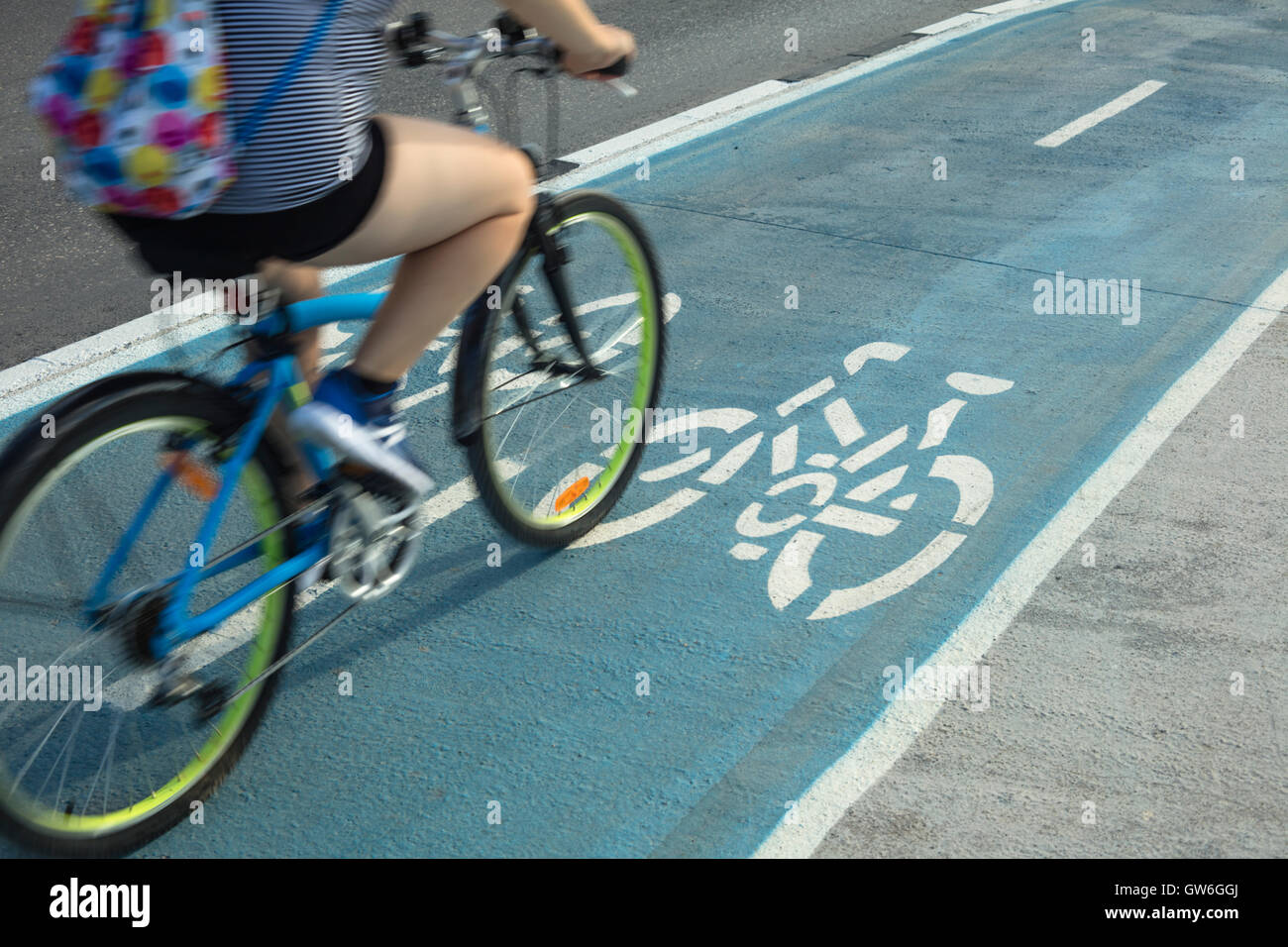 Person riding a bike on bicycle lane or cycle path outdoors Stock Photo ...