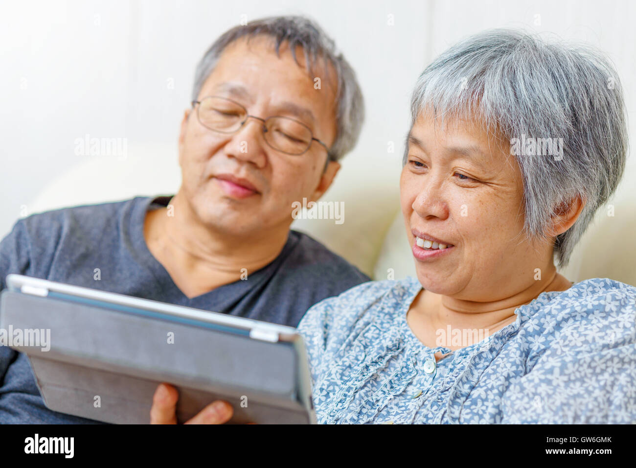 Asian elderly couple using digital tablet Stock Photo - Alamy